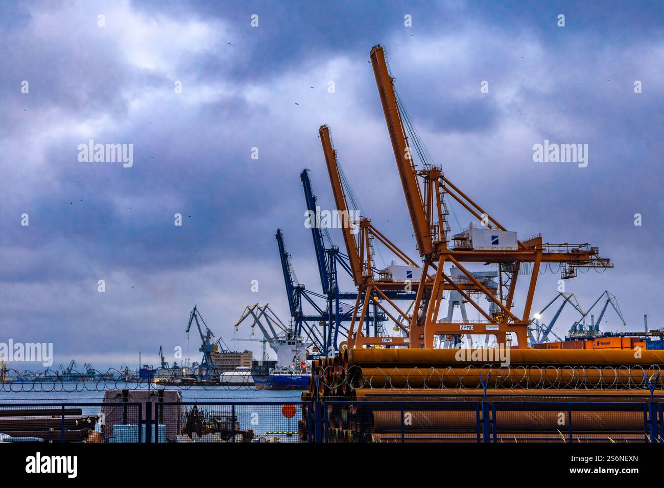 Tall cranes in the port, unloading goods from containers from ships, cargo port in Gdynia Stock ...