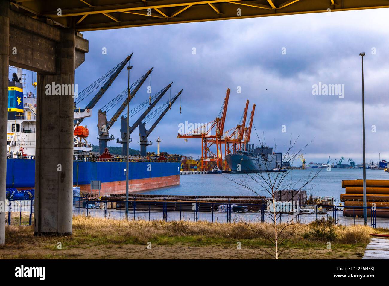 Tall cranes in the port, unloading goods from containers from ships, cargo port in Gdynia Stock ...