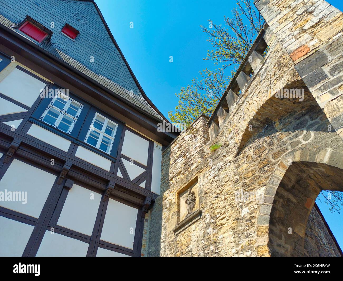 Medieval town gate and half-timbered house in the old town of Goslar ...
