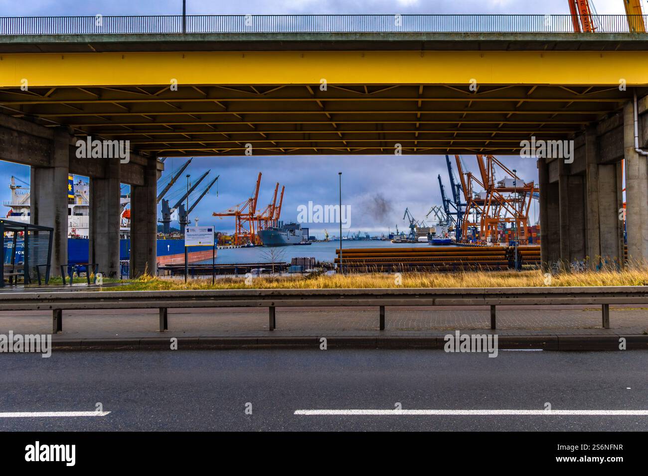 Tall cranes in the port, unloading goods from containers from ships, cargo port in Gdynia Stock ...