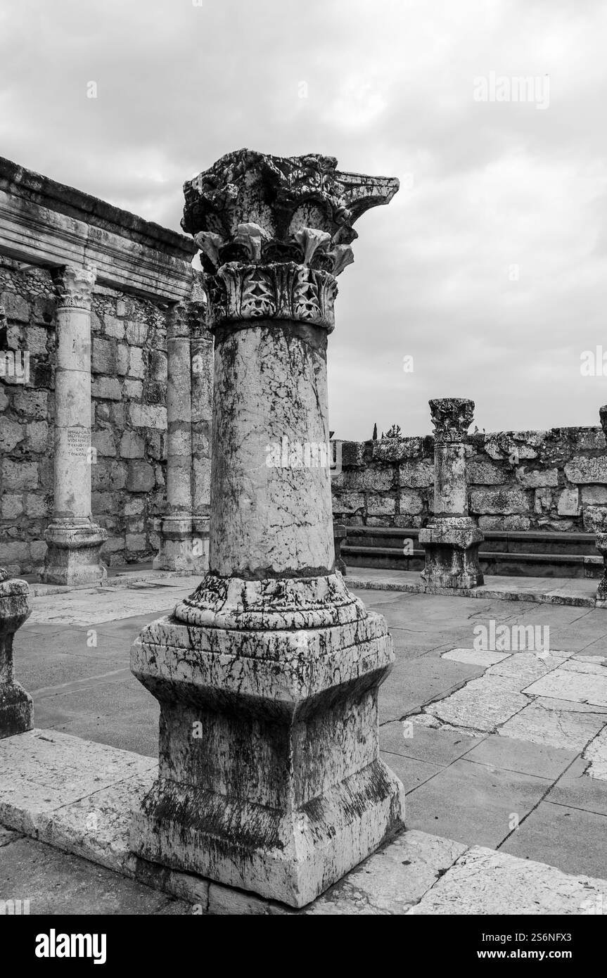 A tall, gray pillar with a bird carved into it. The pillar is ...