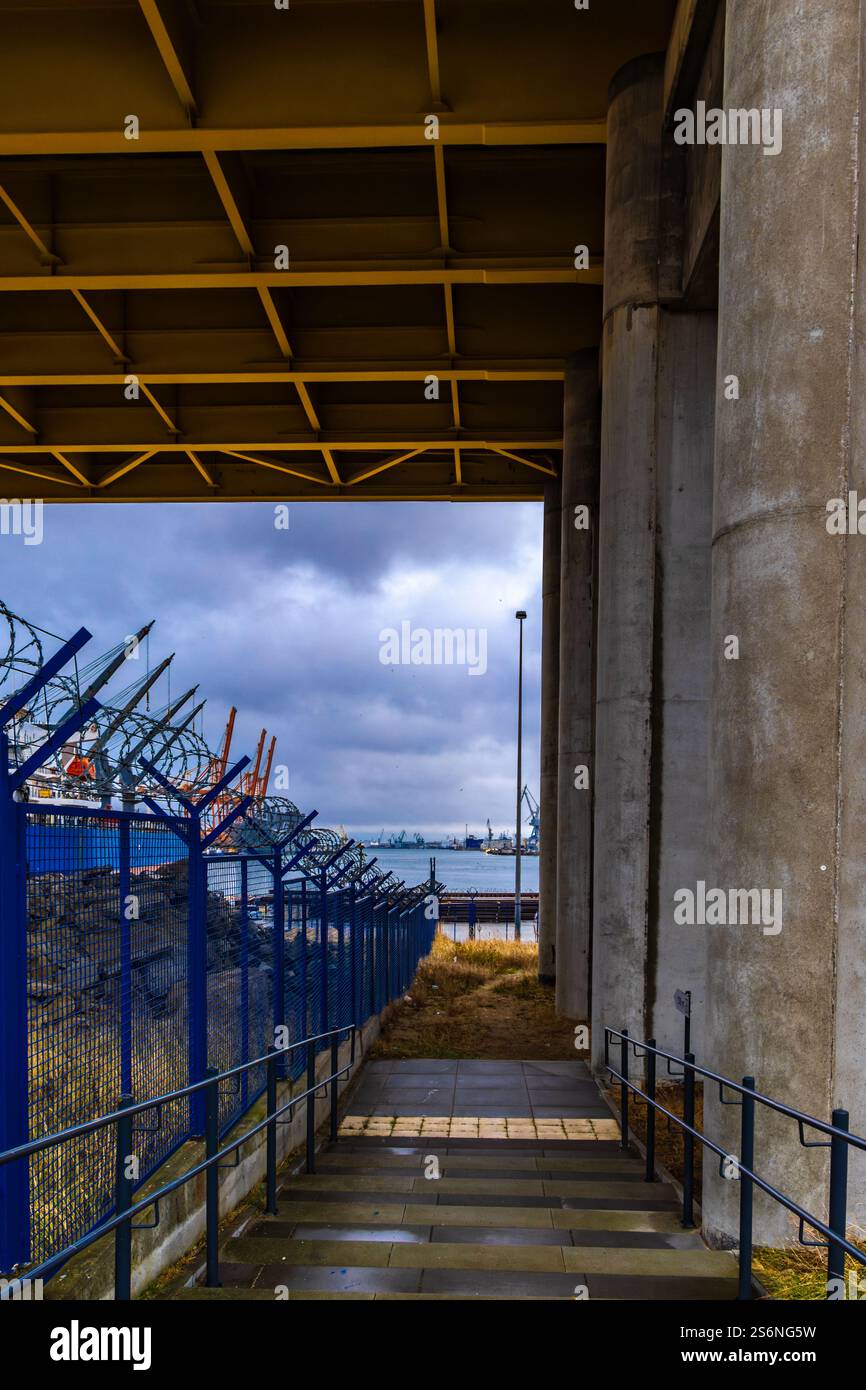 Tall cranes in the port, unloading goods from containers from ships, cargo port in Gdynia Stock ...
