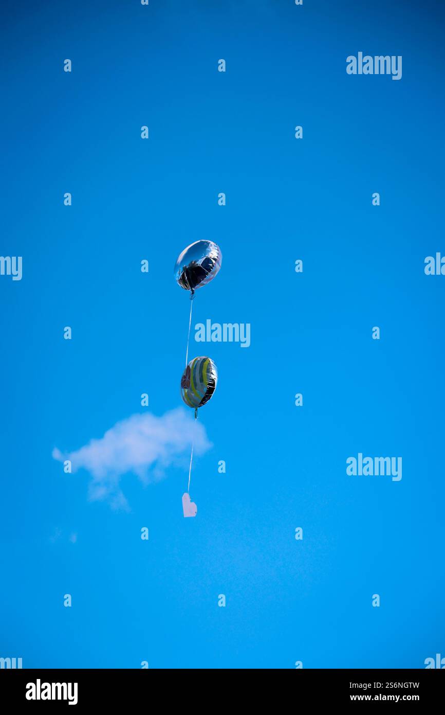 Balloons with greetings and messages rise into the sky at a wedding ...