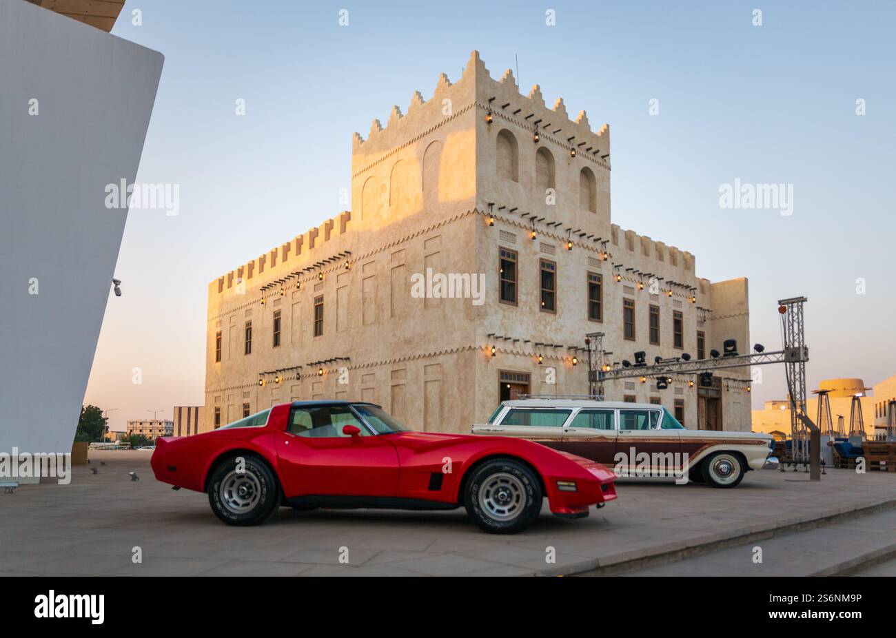 A red luxury car and an old car at the Qatif Car Show in Qatif, Saudi ...