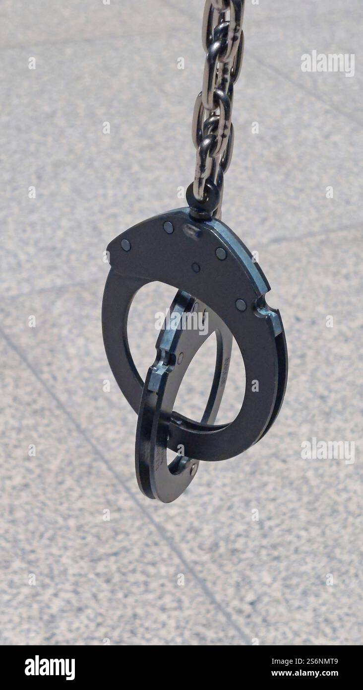 Handcuffs in each other Stock Photo - Alamy