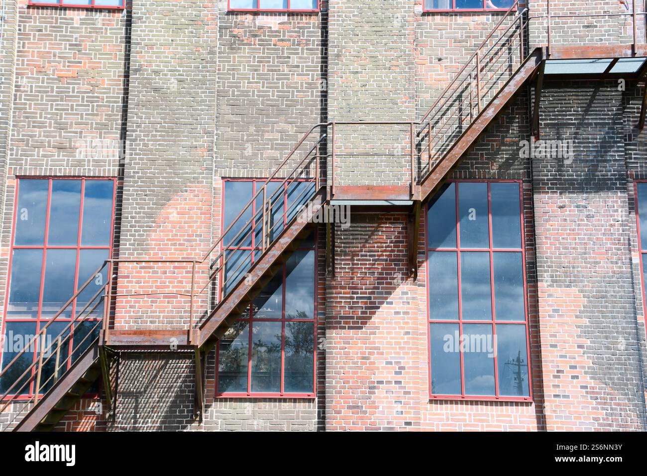 Rusted external steel staircase on brick factory building Stock Photo ...