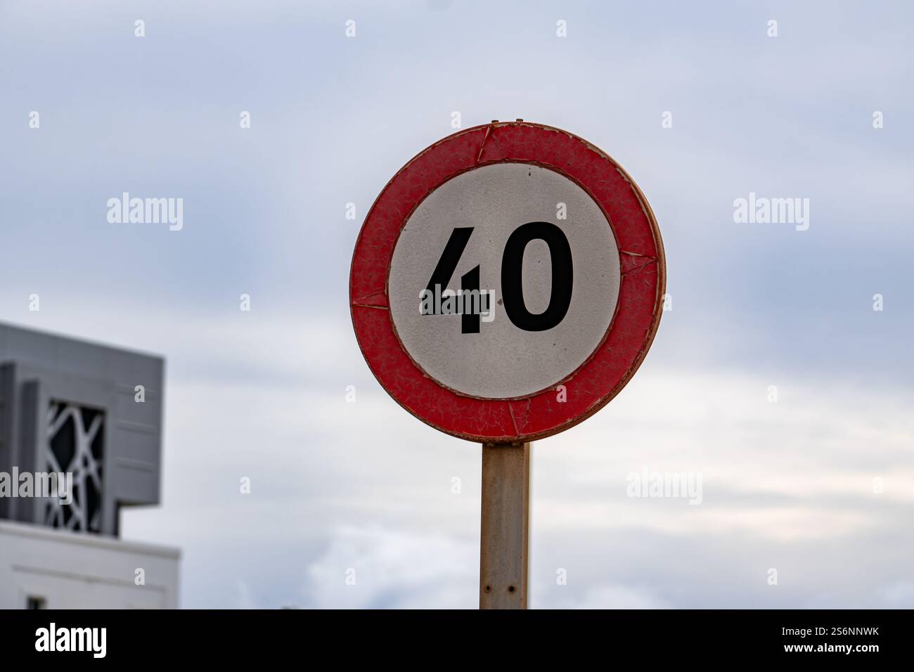 A red and white sign with the number 40 on it. The sign is on a pole ...