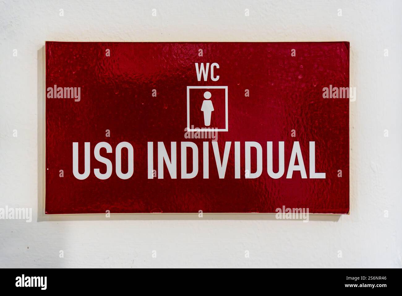 A red sign with a white border that says "WC" and "USO Individual" in ...