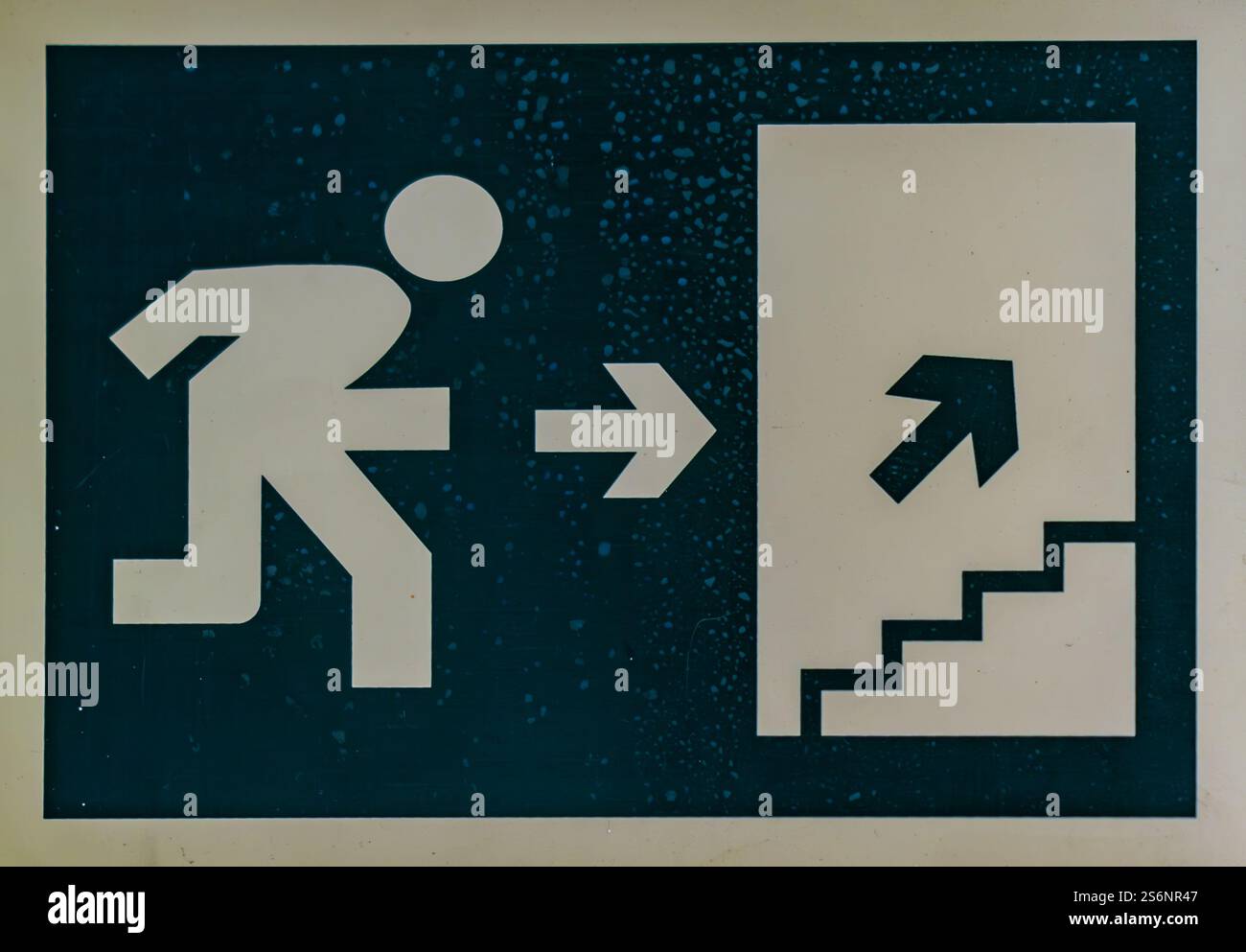 A sign with a man running and an arrow pointing up. The sign is blue ...