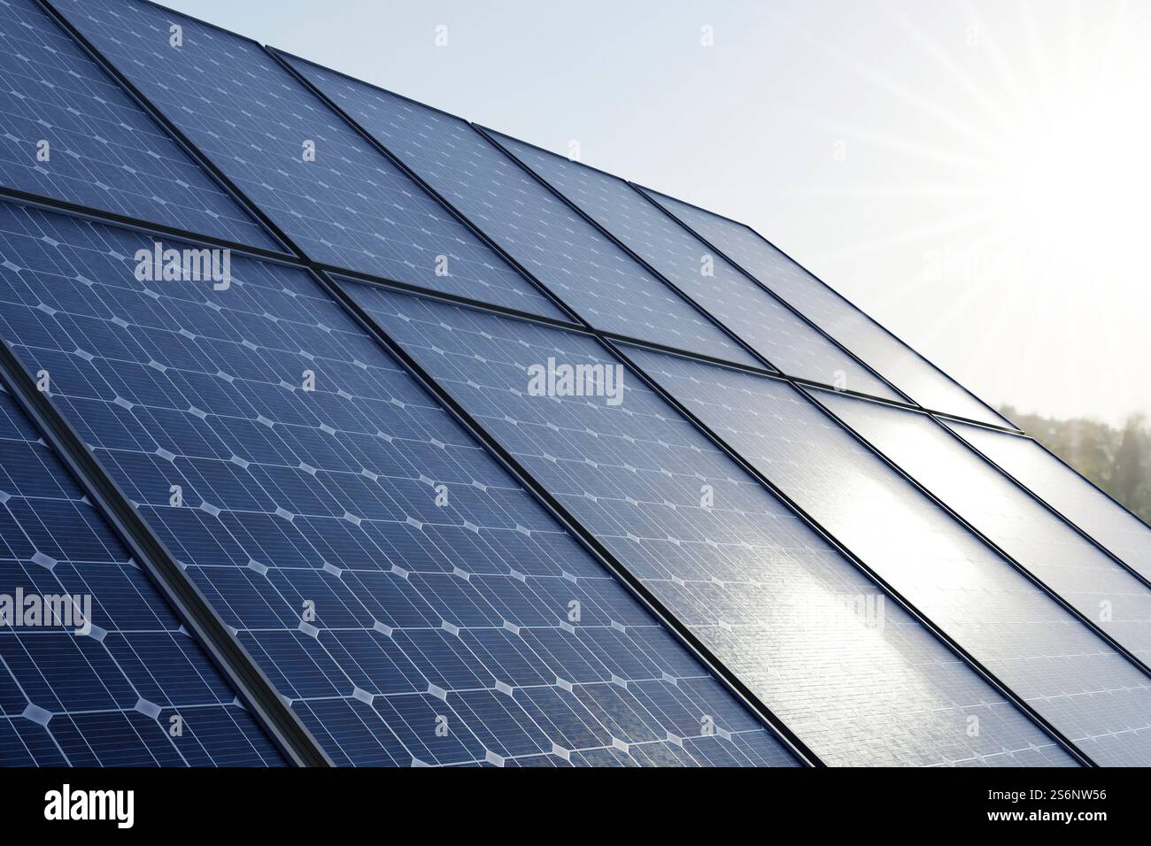 Solar power plant against the rising sun, selective focus on the first ...