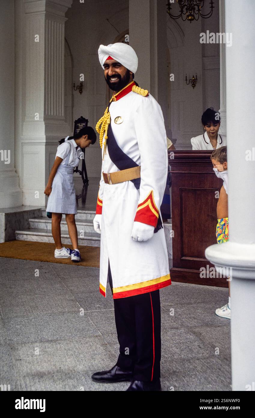 Sikh doorman in military uniform on duty at the famous Raffles Hotel in ...