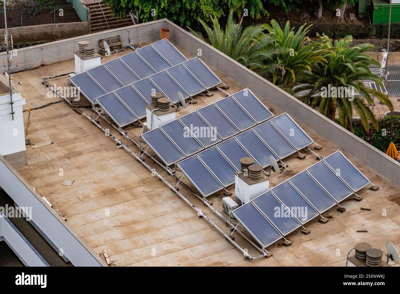 A rooftop with solar panels on it. The panels are arranged in a row and ...