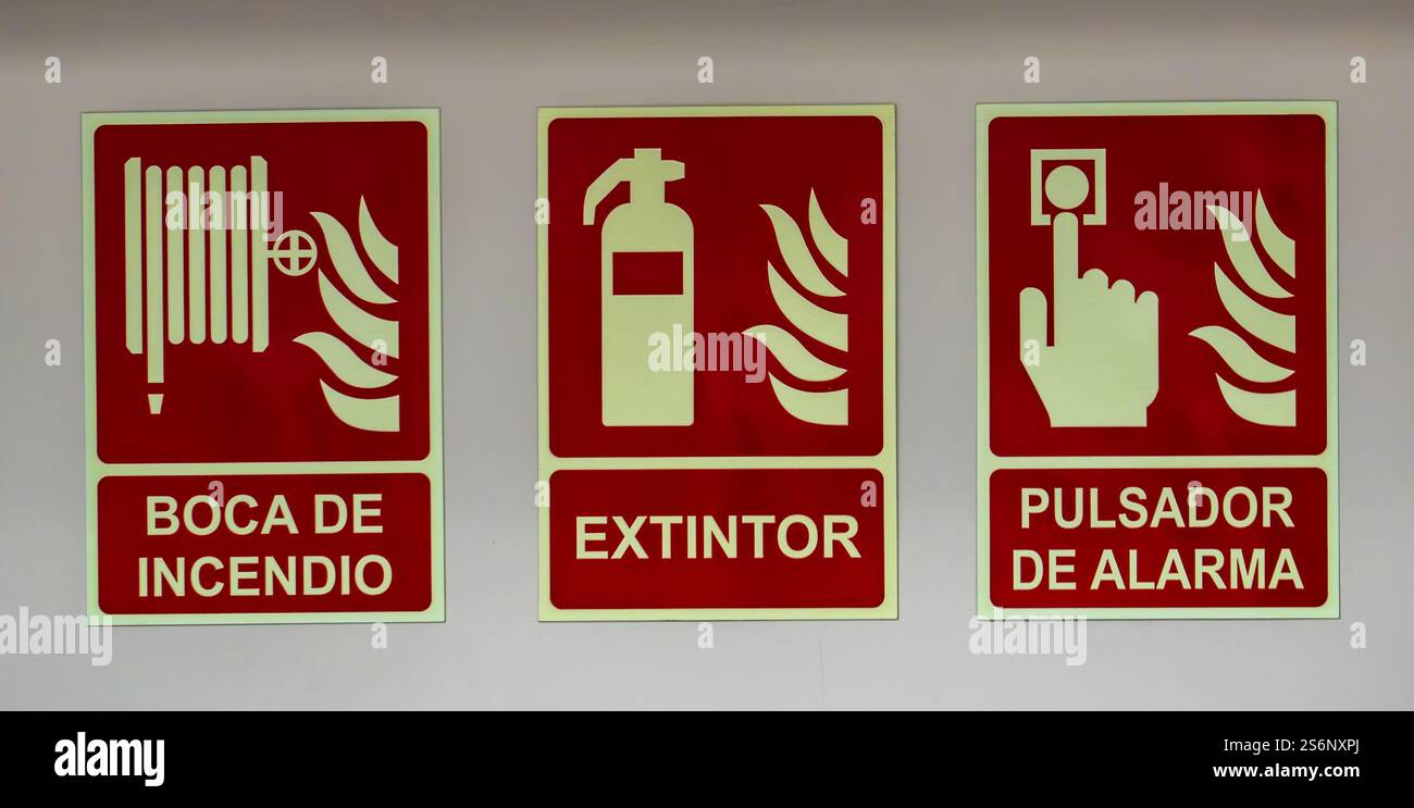 Three signs with a red background and a white border. The top sign has ...