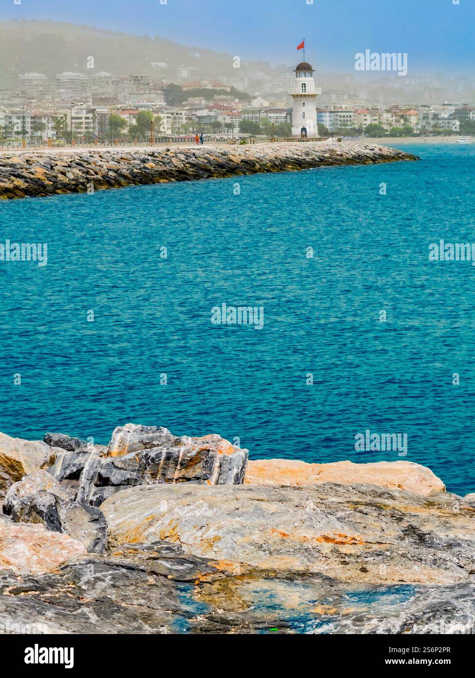 Newly constructed stone promenade and the lighthouse in the bay of ...