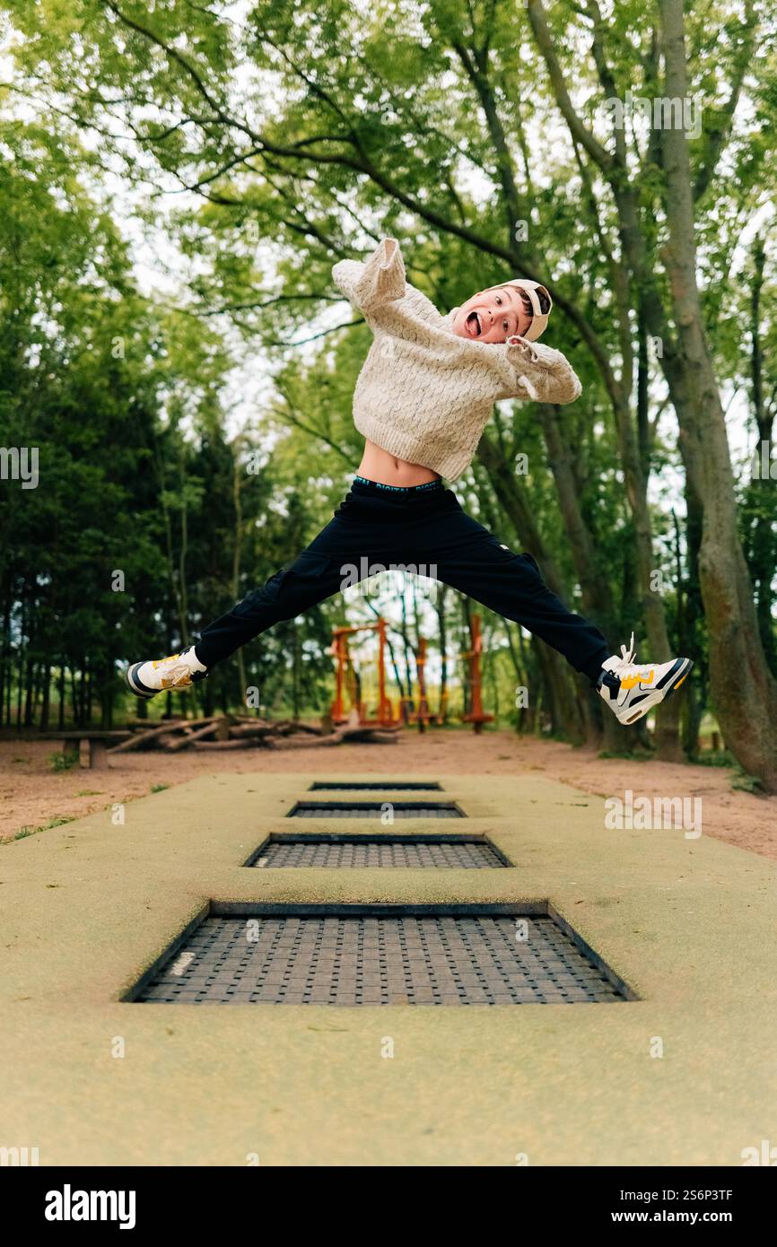 Teen boy jumping over several trampolines on a sports ground Stock ...