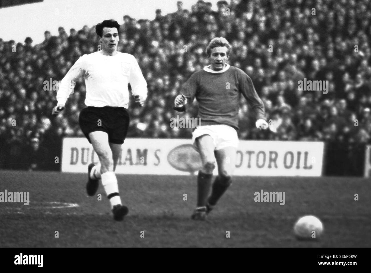 Manchester United's Denis Law, right, and Fulham's Bobby Robson give ...