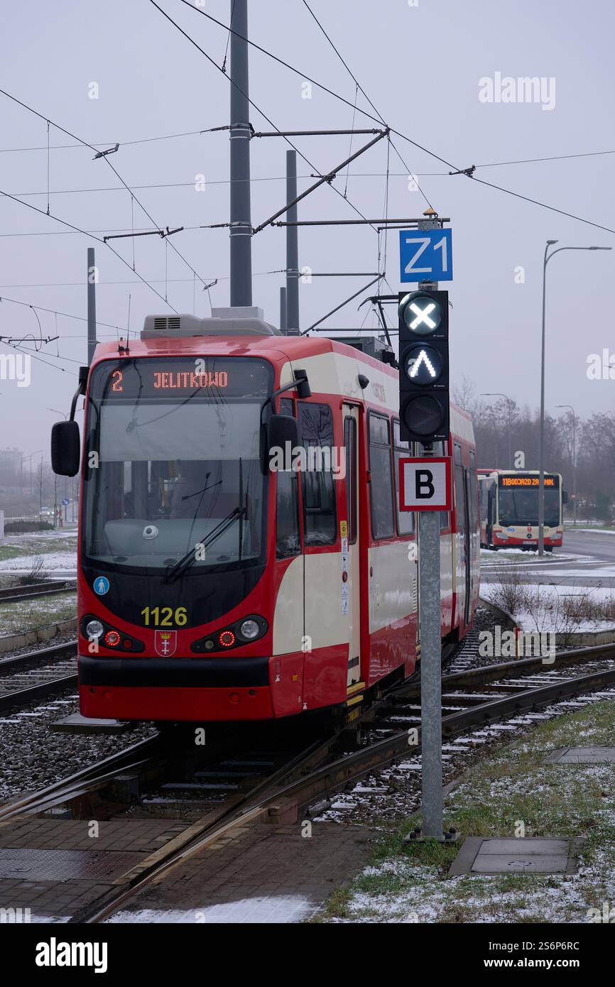 Red electric tram on snowy rails Stock Photo - Alamy