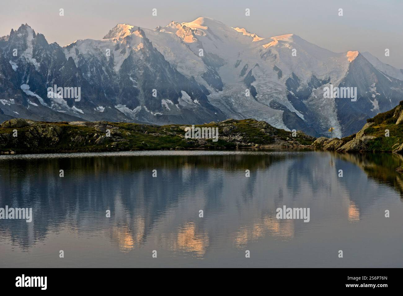At the mountain lake Lac Blanc, morning sun on the Mont Blanc massif ...