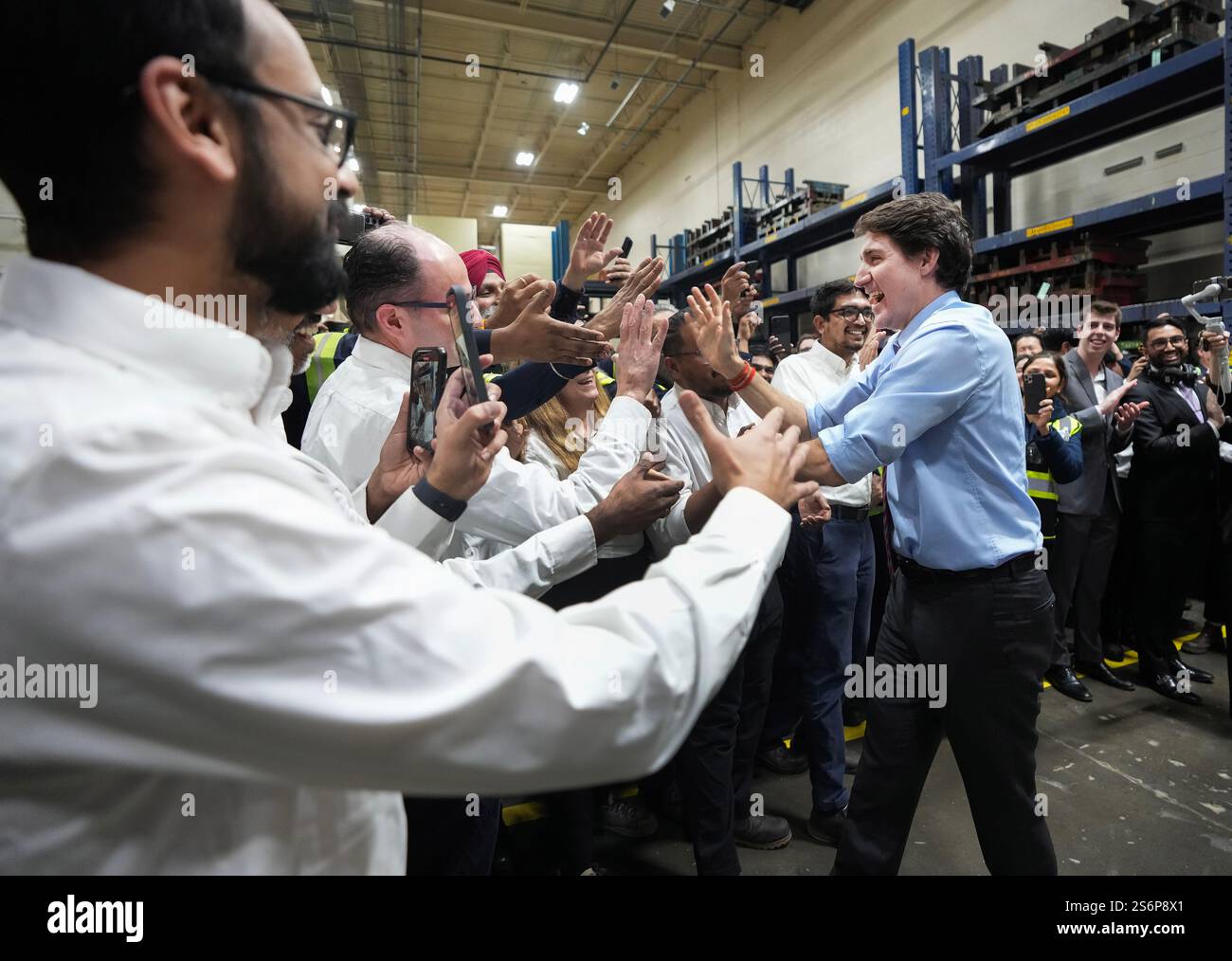 Prime Minister Justin Trudeau, right, meets employees at the Martinrea ...