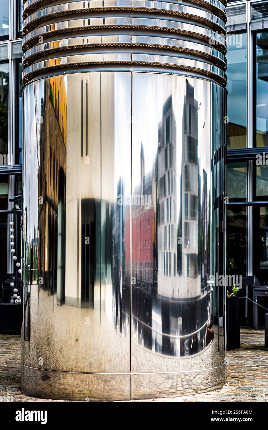 Modern exhaust air column with a blurred reflection of a Cologne street ...