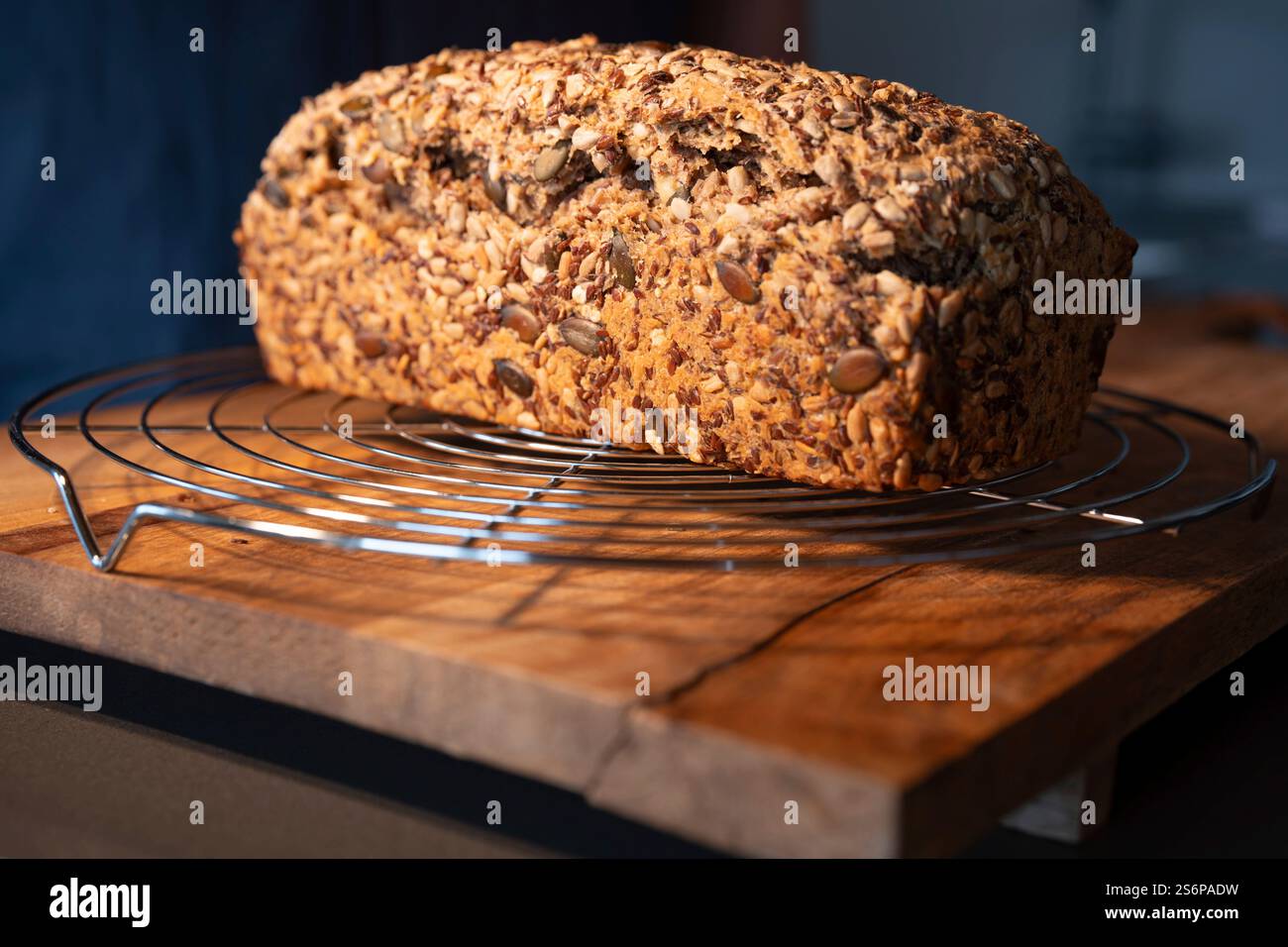 Freshly baked whole grain bread on wooden work surface. Food ...