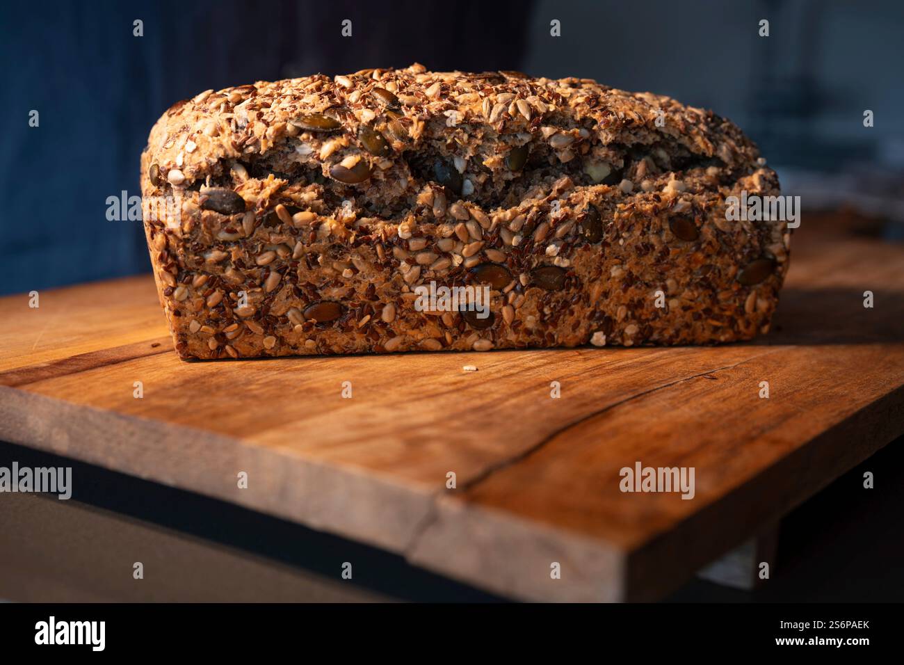 Freshly baked whole grain bread on wooden work surface. Food ...
