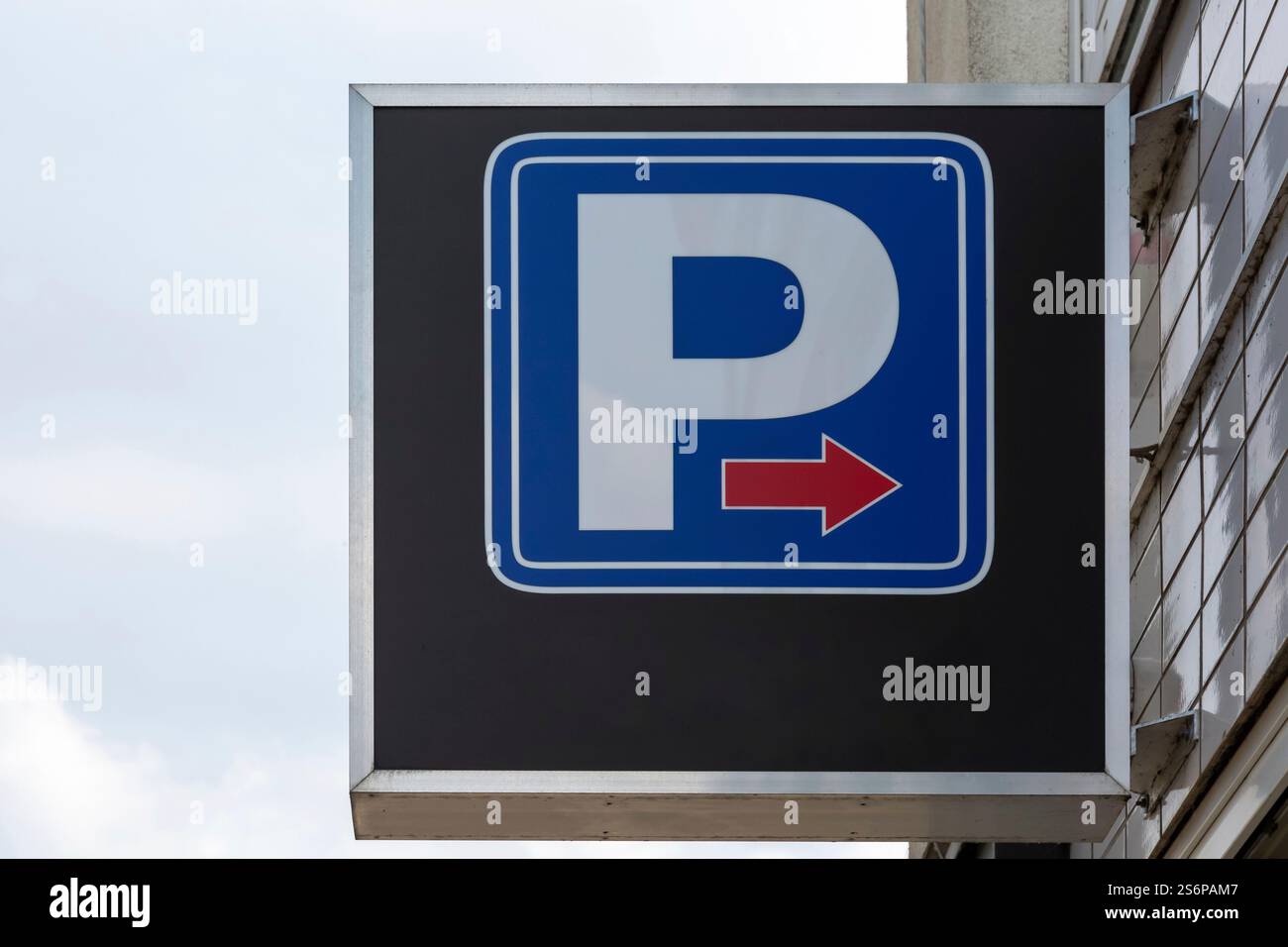 A blue sign with the symbol "P" for parking and a red arrow pointing to ...