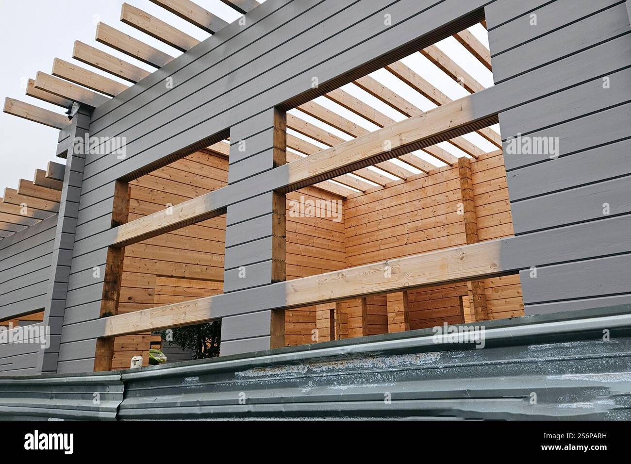 Eco-Friendly Multi-Story Timber Home with Large Windows in the process ...