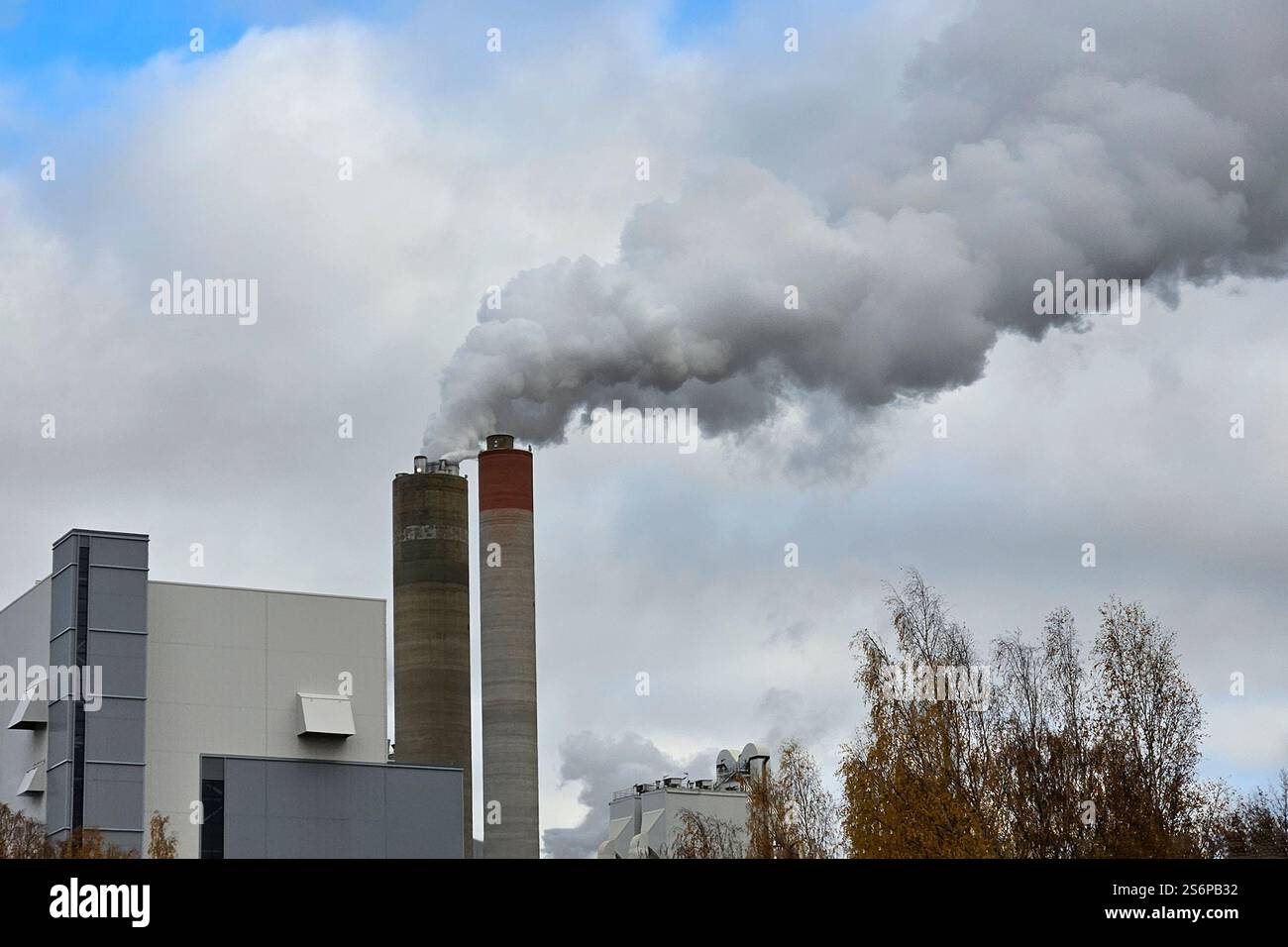 Industrial Emissions. A factory building with a prominent chimney ...