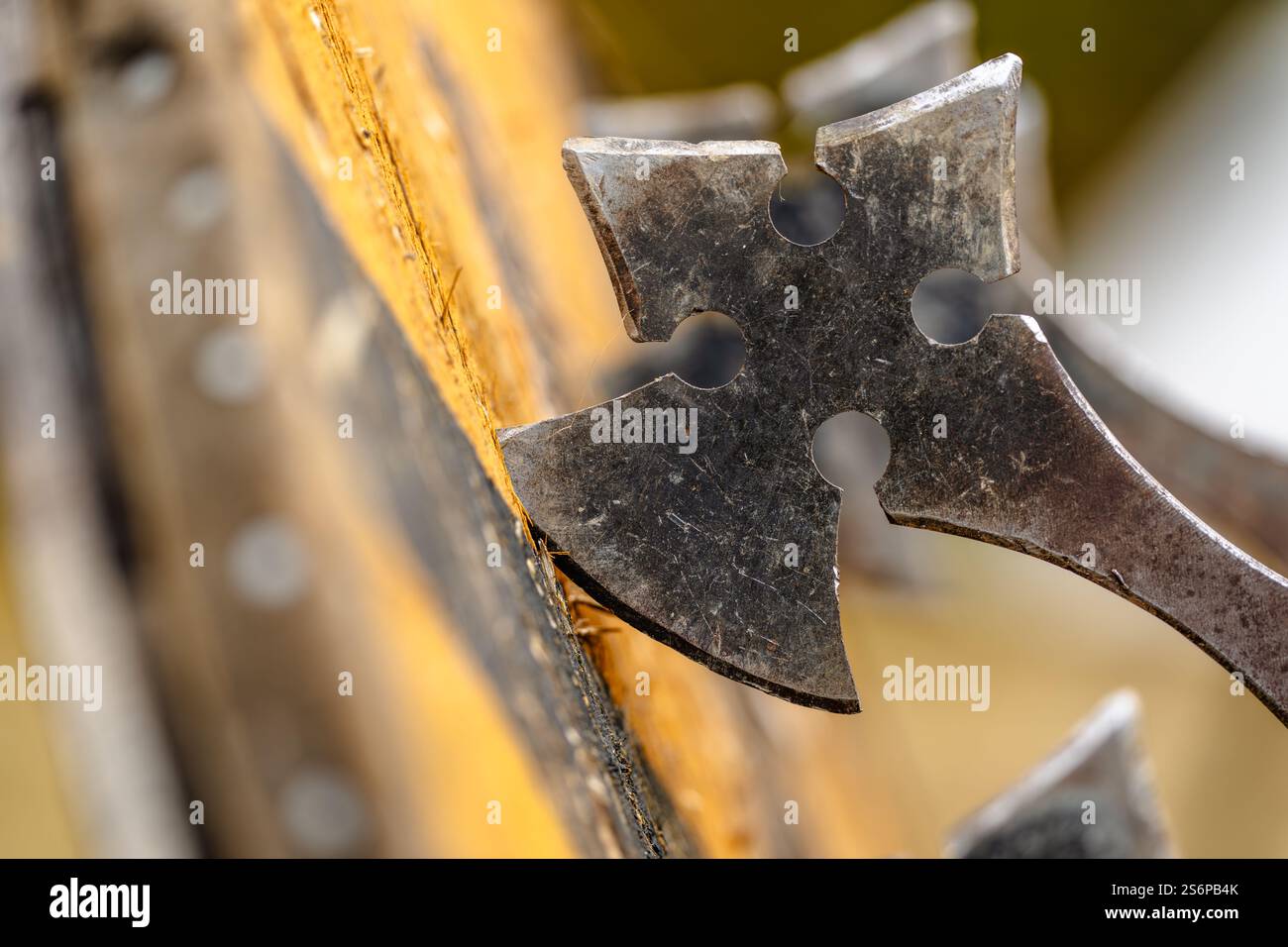A black and silver axe is on a wooden surface. The axe is sharp and has ...