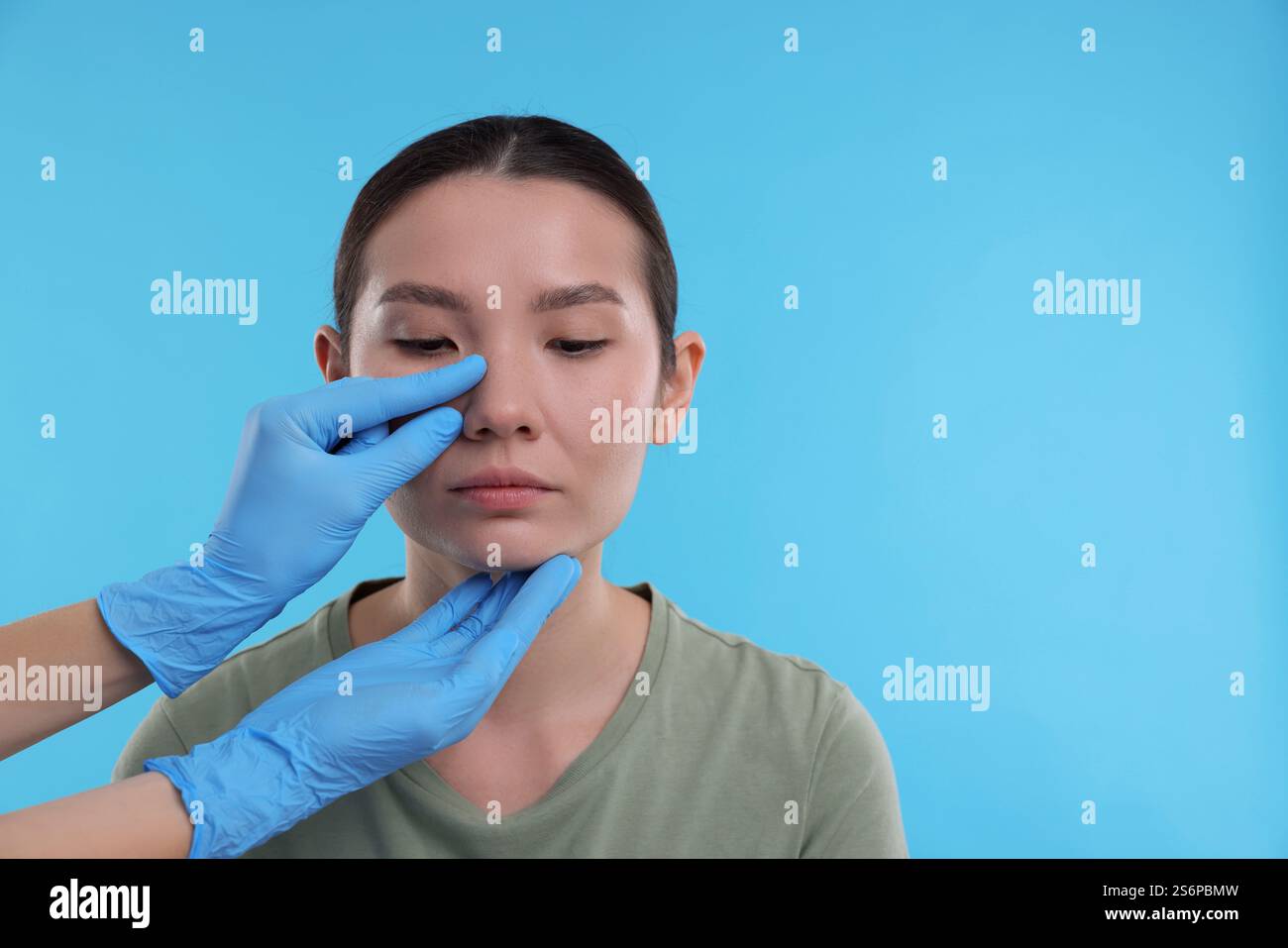 Doctor checking patient's nose before plastic surgery operation on ...