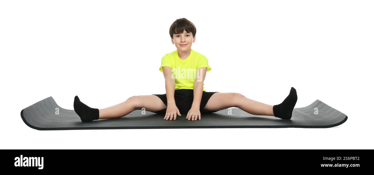 Boy exercising on fitness mat against white background. Sport activity ...
