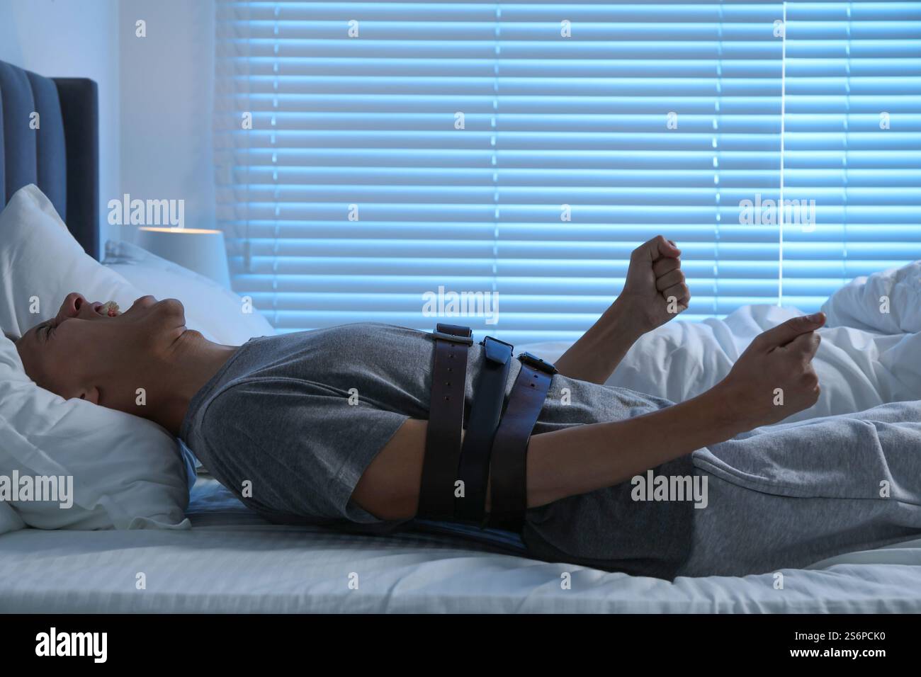 Man in sleepwalking condition screaming on bed Stock Photo - Alamy