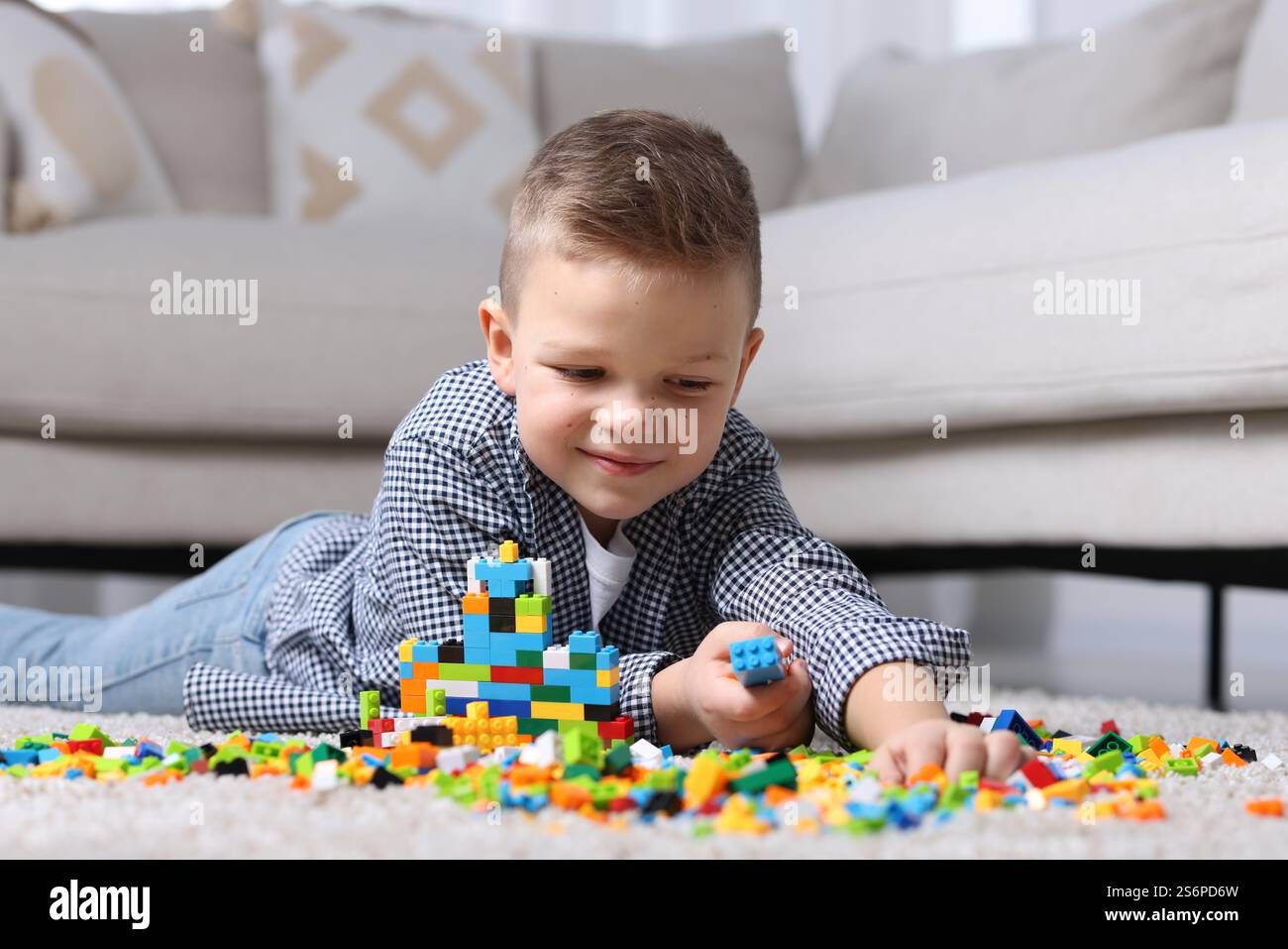 Cute boy playing with building blocks on floor at home Stock Photo - Alamy