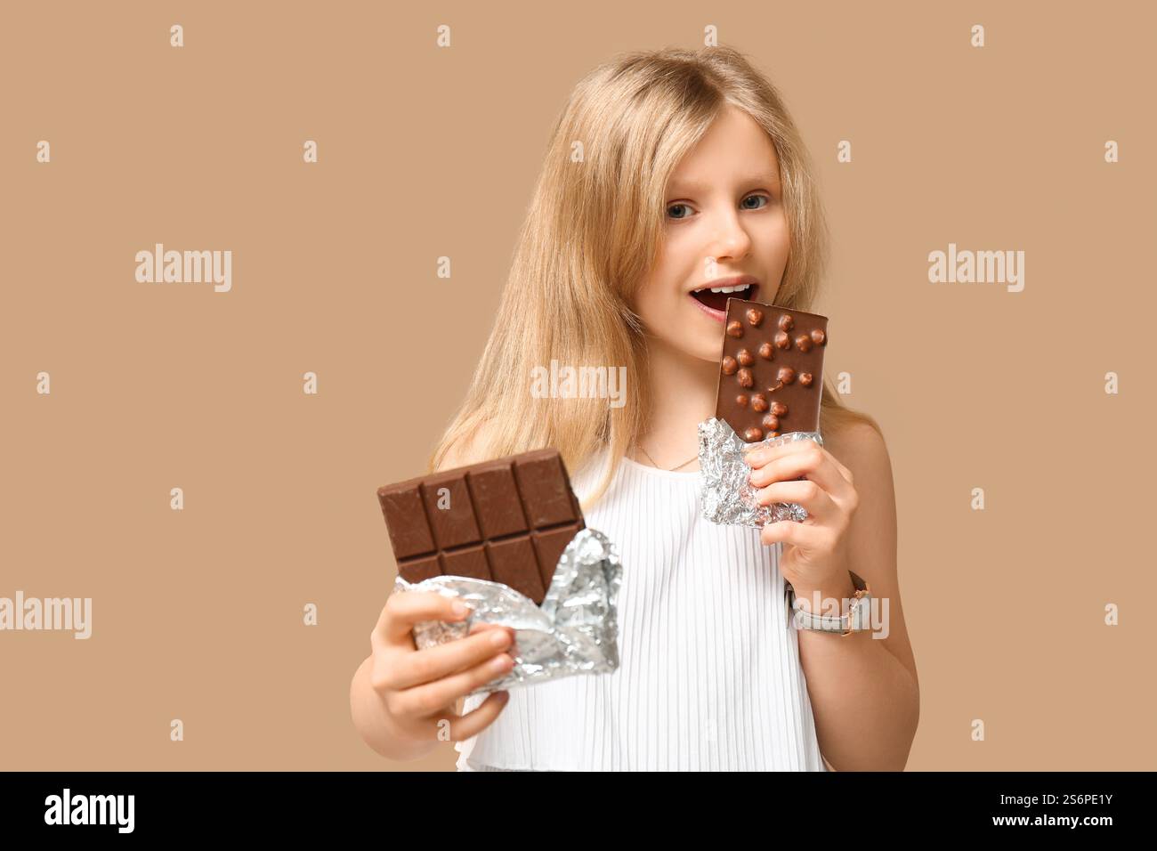 Cute little girl with sweet chocolate bars on brown background Stock ...