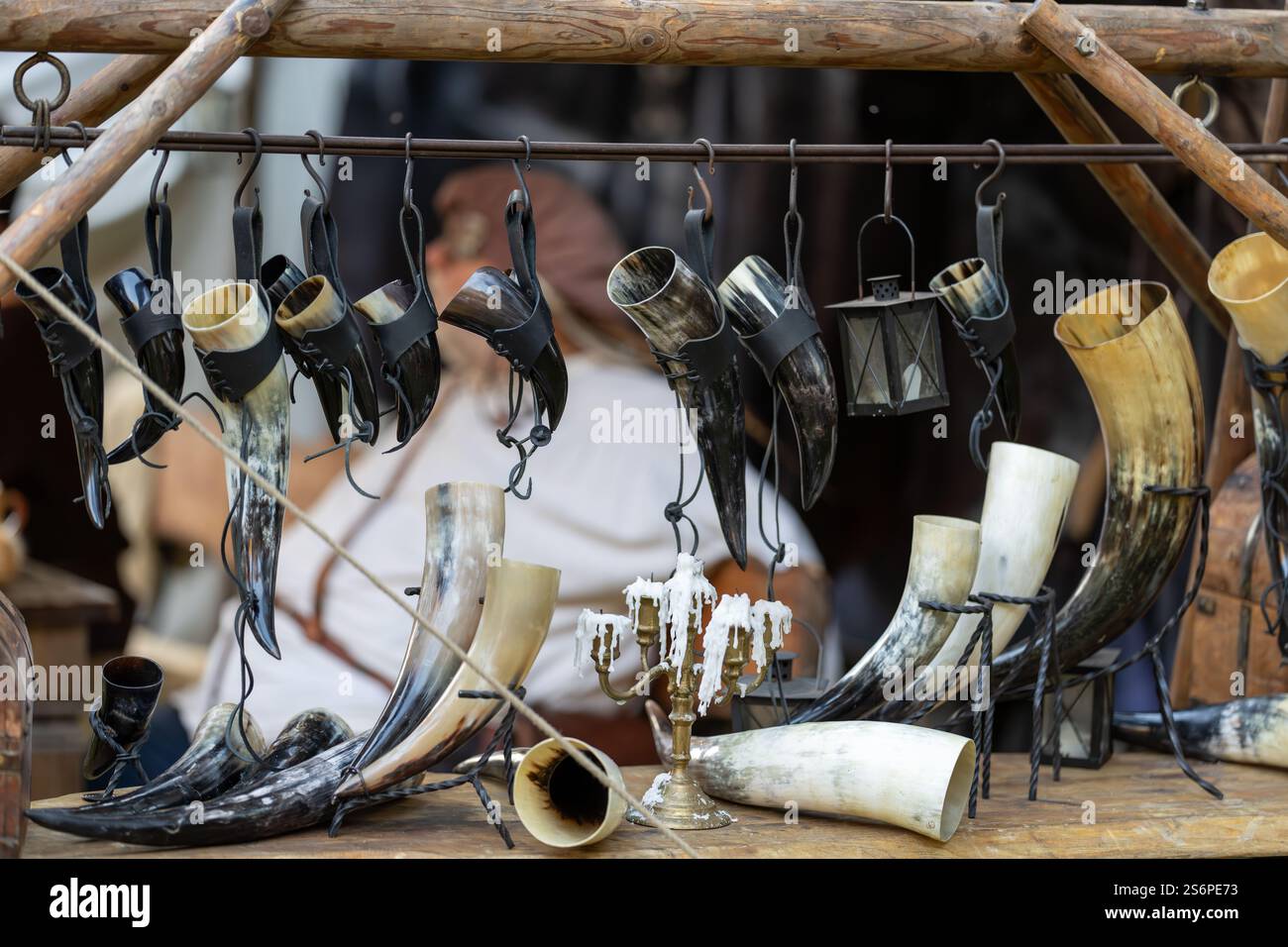A display of horns and other items hangs from a wooden rack. The ...