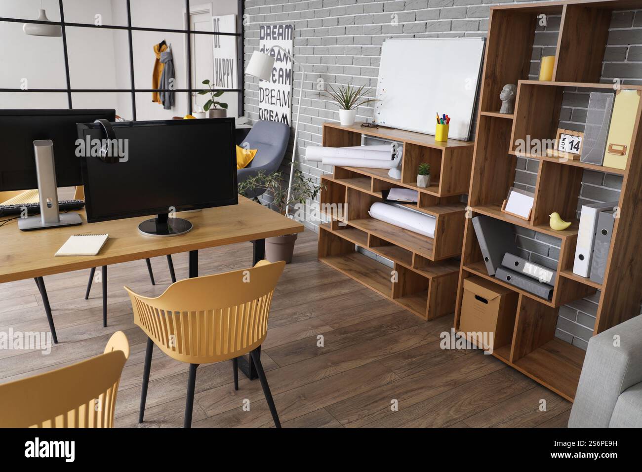 Interior of stylish office with workplace and shelf units Stock Photo ...