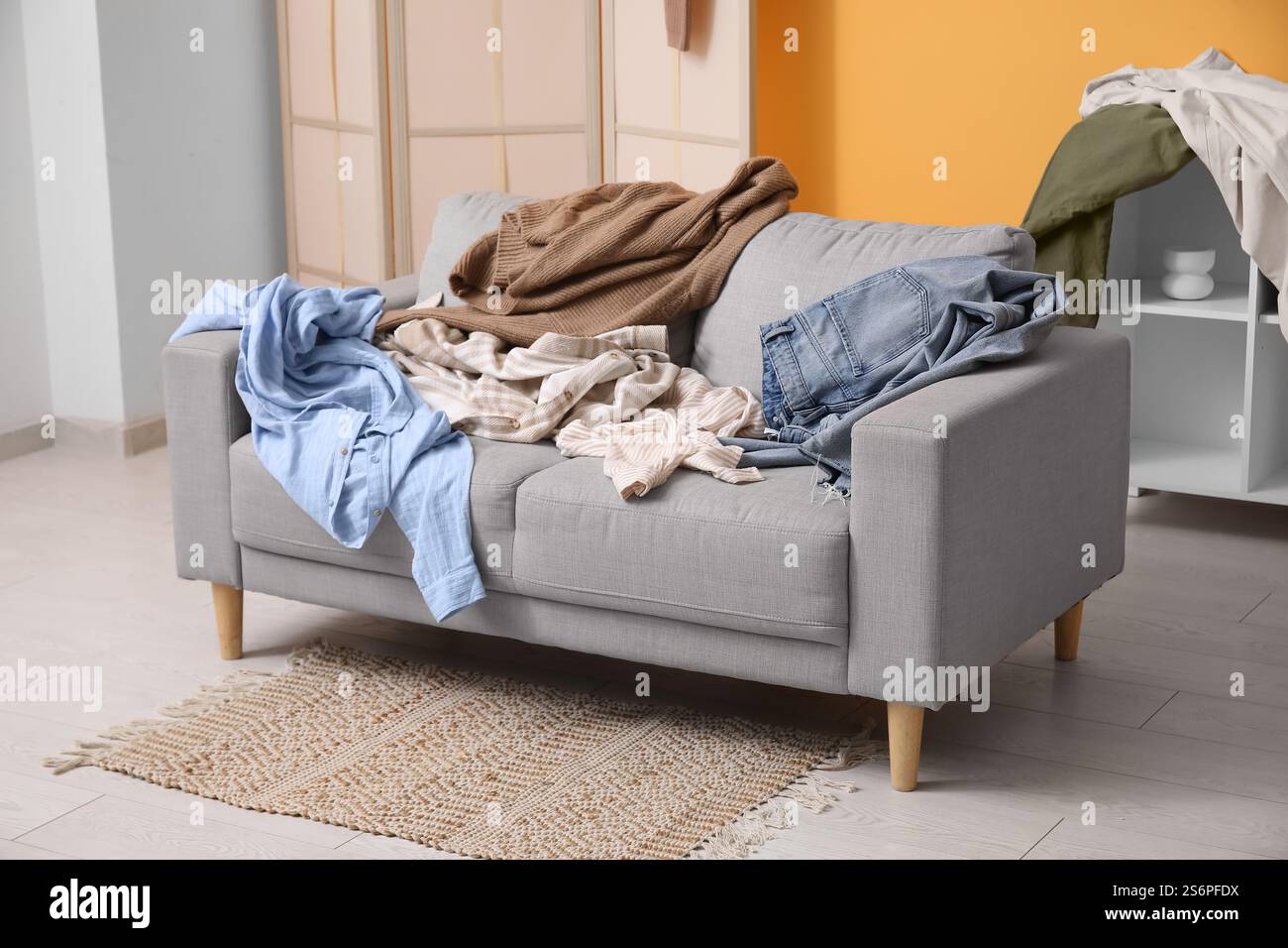 Interior of messy living room with folding screen and different ...