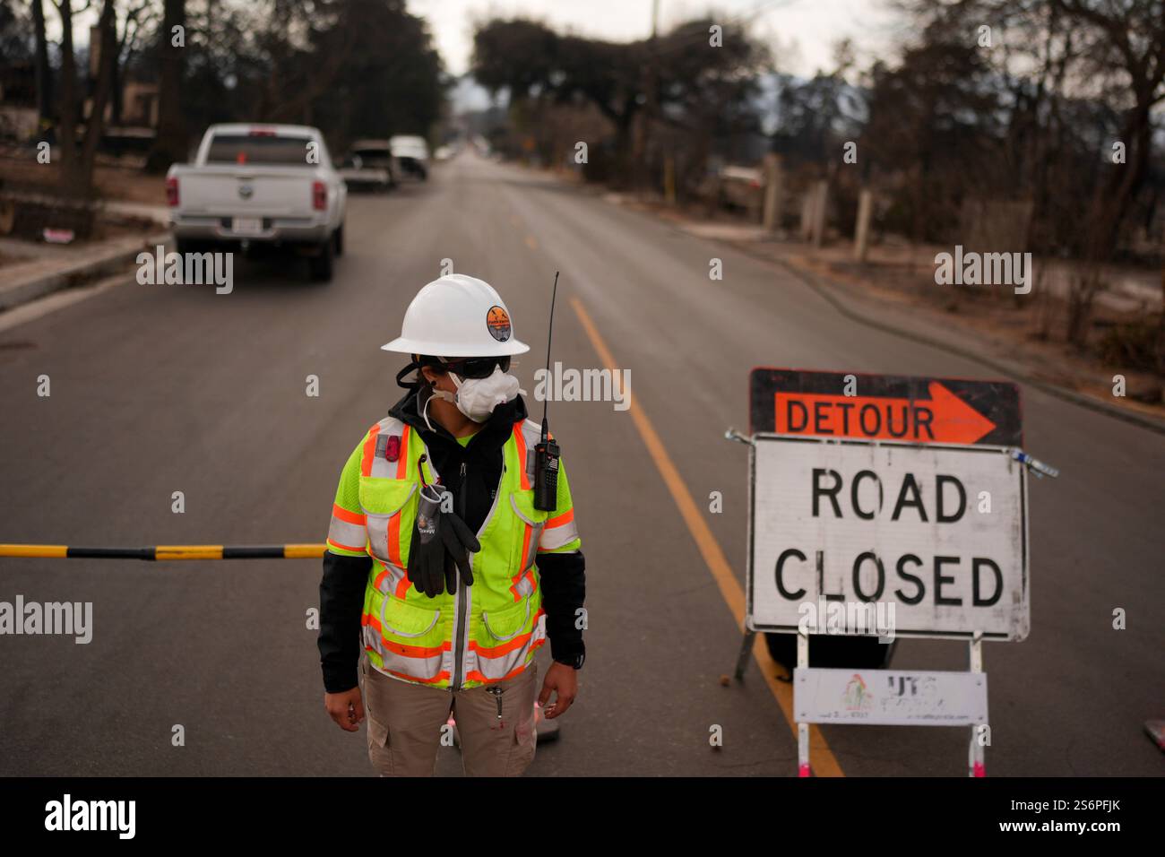 Emeralda Urena works at a check point leading to the damage zone of the ...