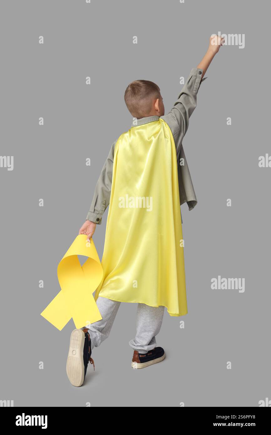 Little boy dressed as superhero with childhood cancer awareness ribbon ...