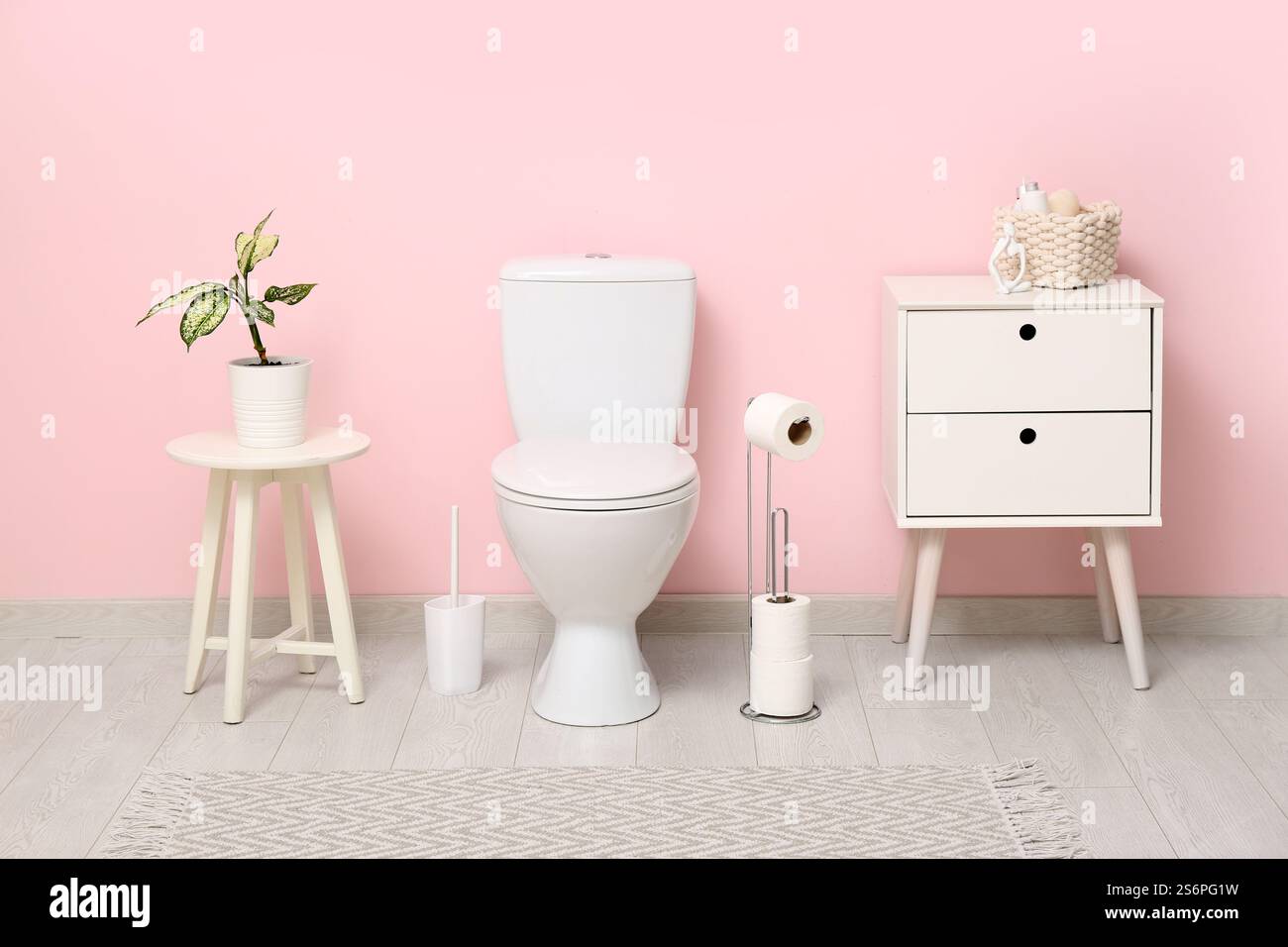 Interior of restroom with toilet bowl, bedside table and coffee table ...