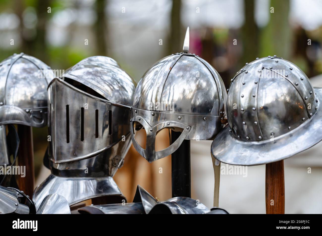 Four helmets are displayed on a table, each with a different design ...