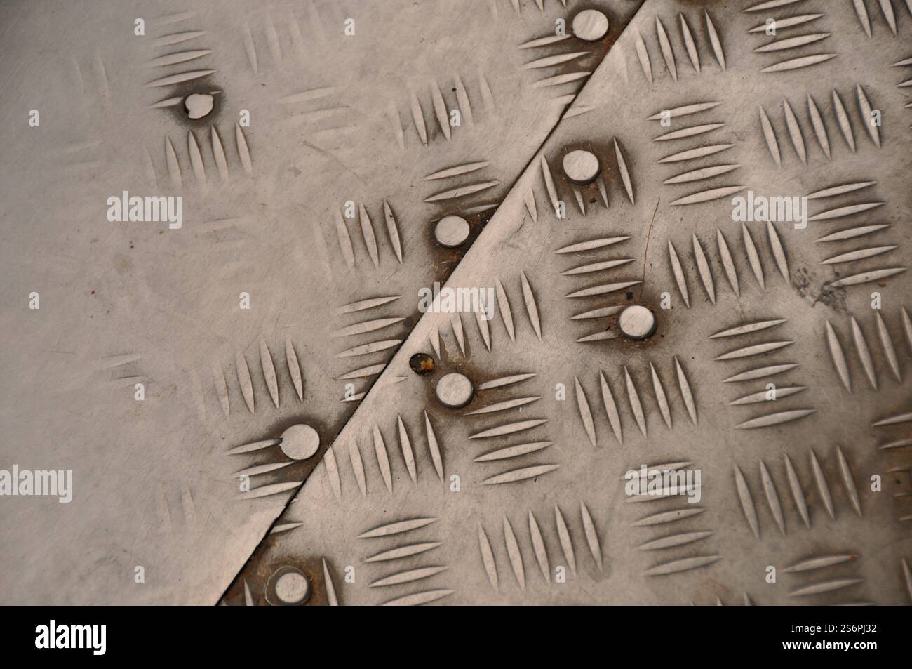 Heavily worn tear plate laid end to end and screwed together Stock ...