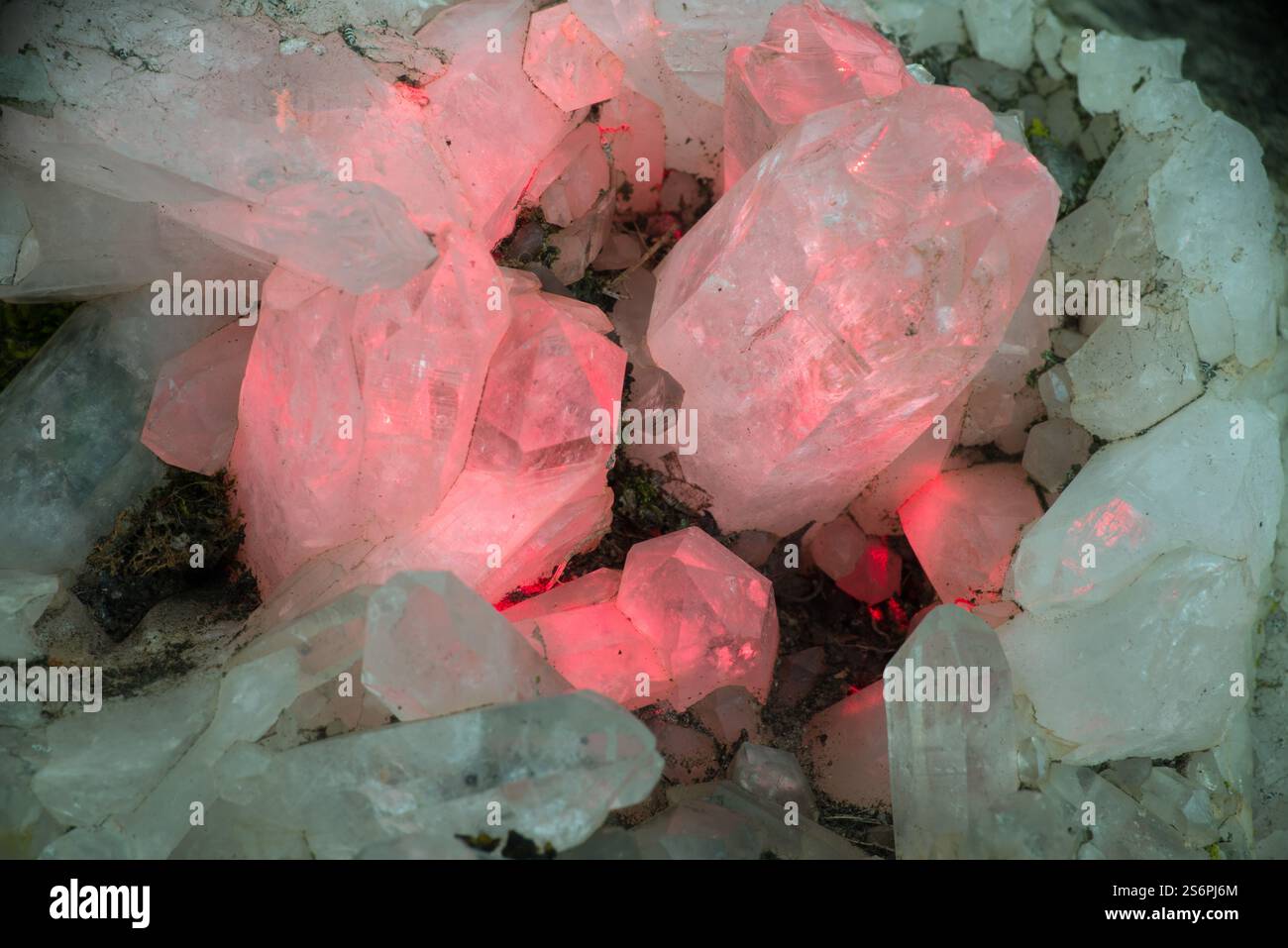 A laser is used to induce a red glow on a collection of quartz crystals ...