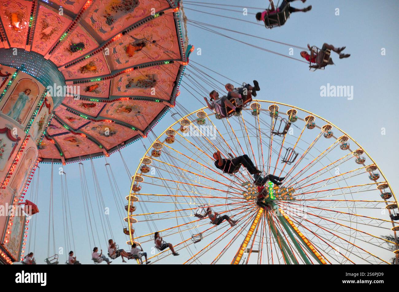 Funfair with Ferris wheel and chain carousel Stock Photo - Alamy