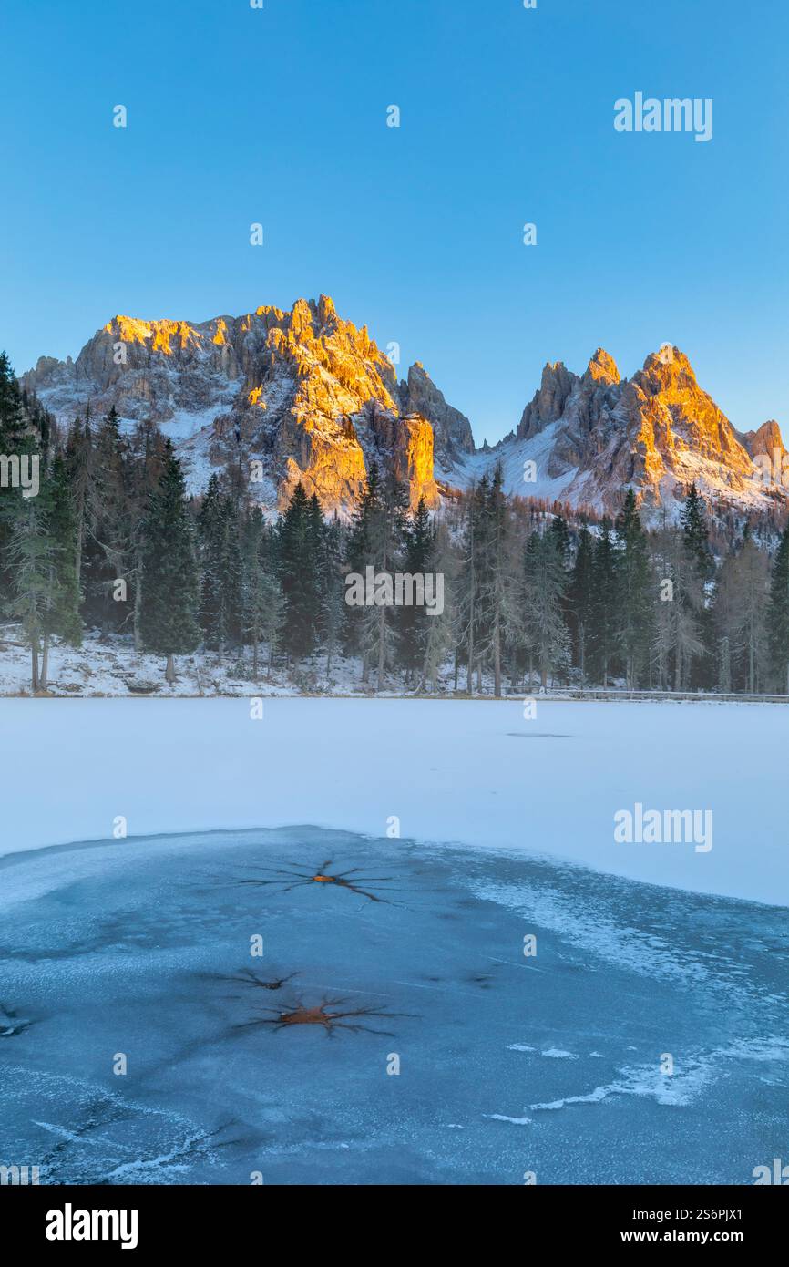 Alpenglow on the Cadini di Misurina seen from the partially frozen and ...