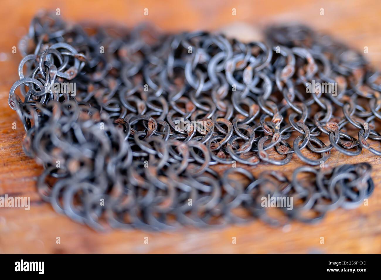 A chain of metal links with a rusted appearance. The chain is made of ...