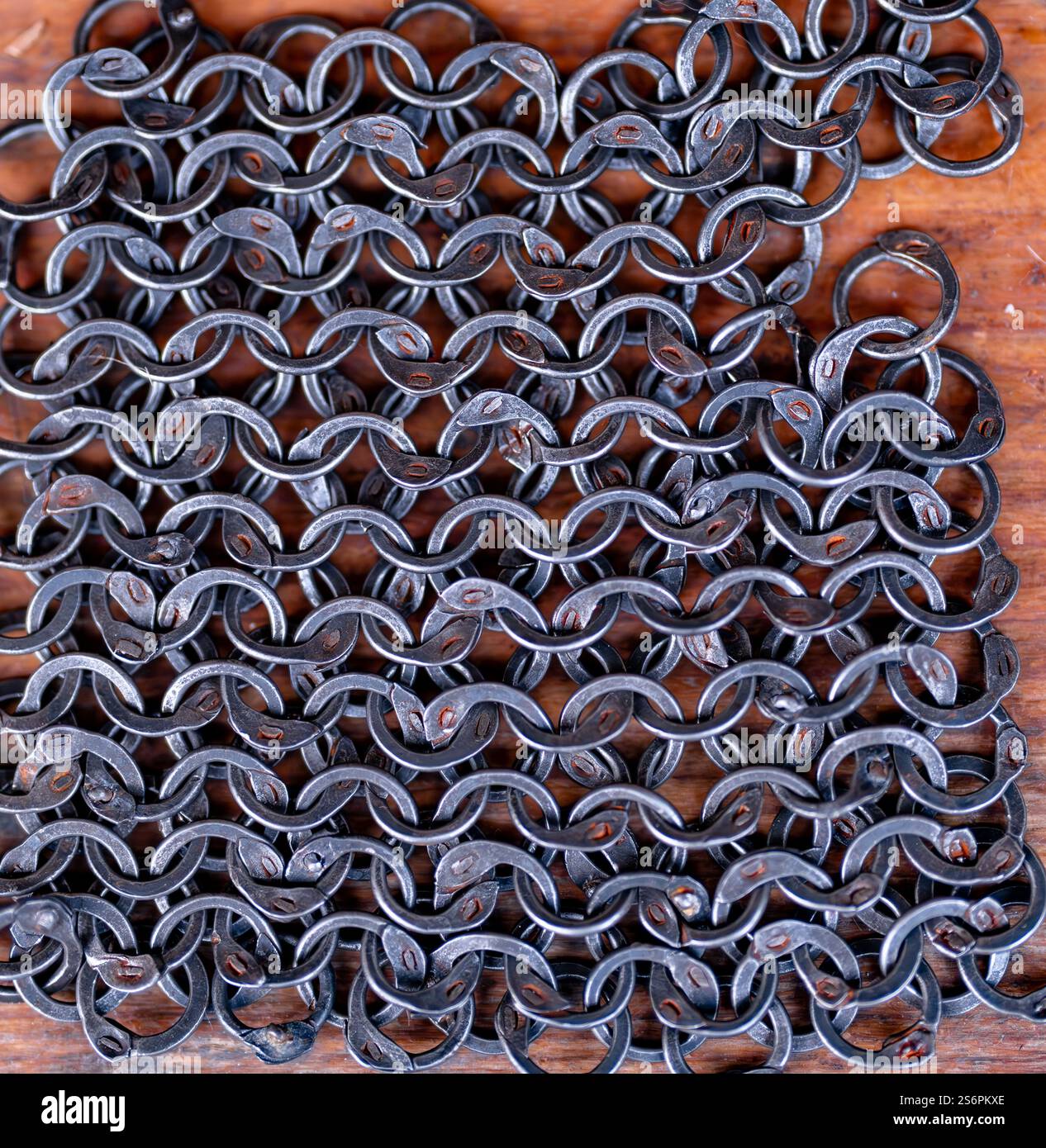 A close up of a chain of metal links. The links are all different sizes ...