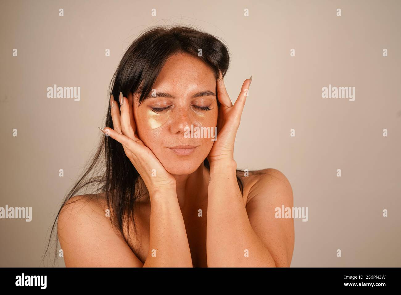 Young attractive smiling cheerful woman puts gel colorless transparent ...