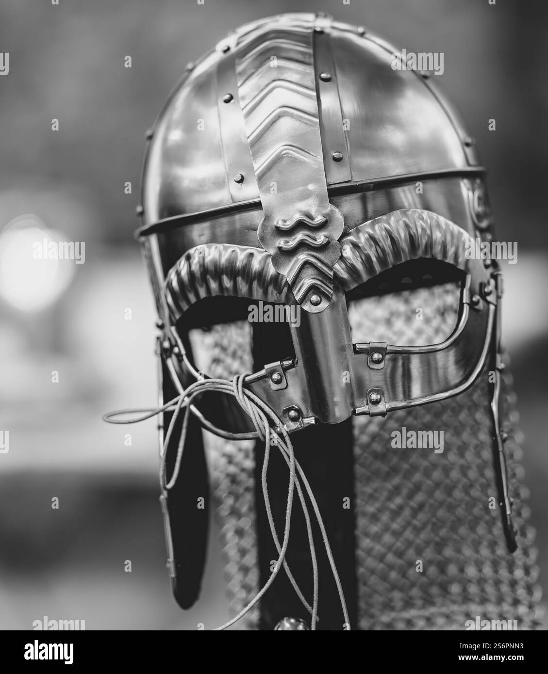 A helmet with a black and silver design. The helmet is made of metal ...